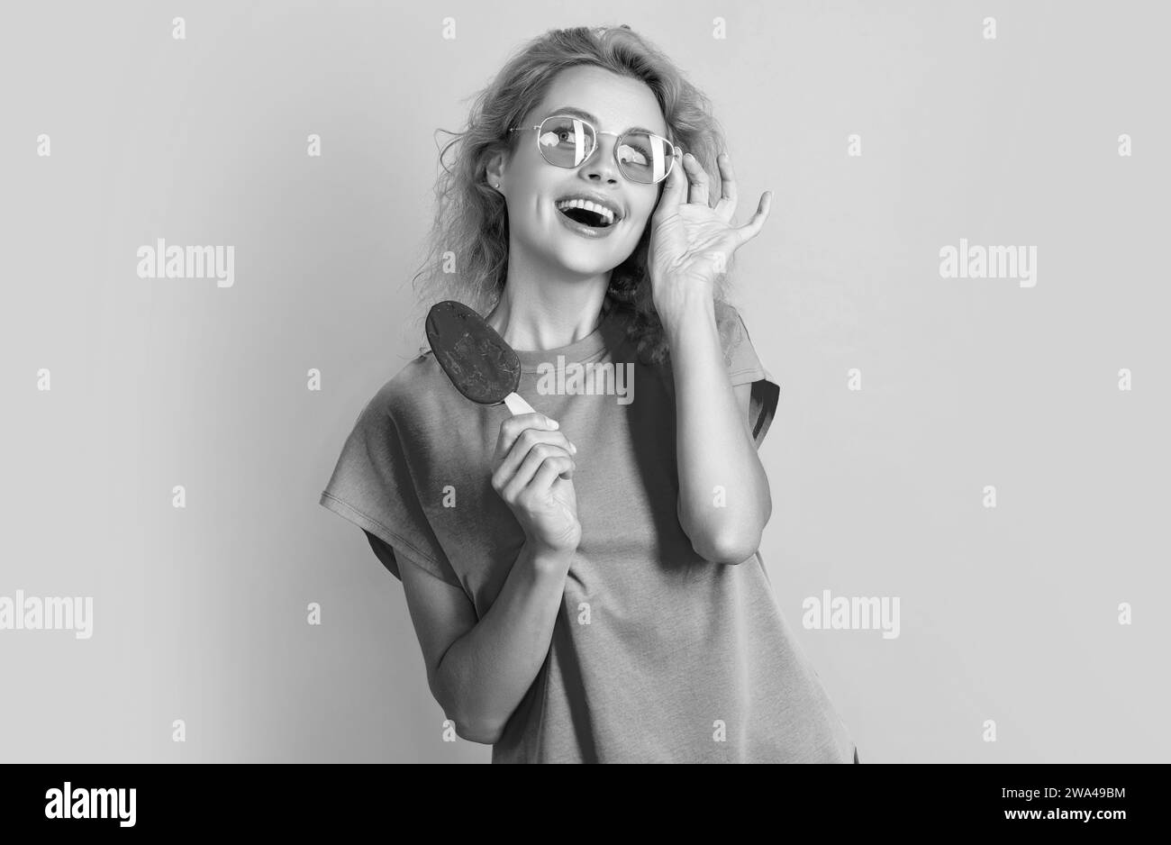cheerful woman with icelolly ice cream isolated on yellow. woman with ...
