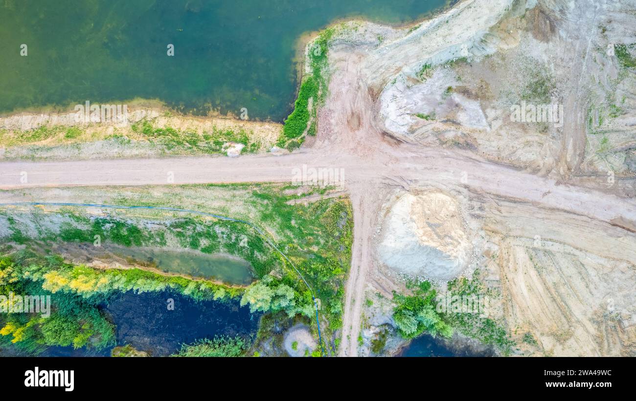 This aerial image presents a stark contrast between a natural water ...