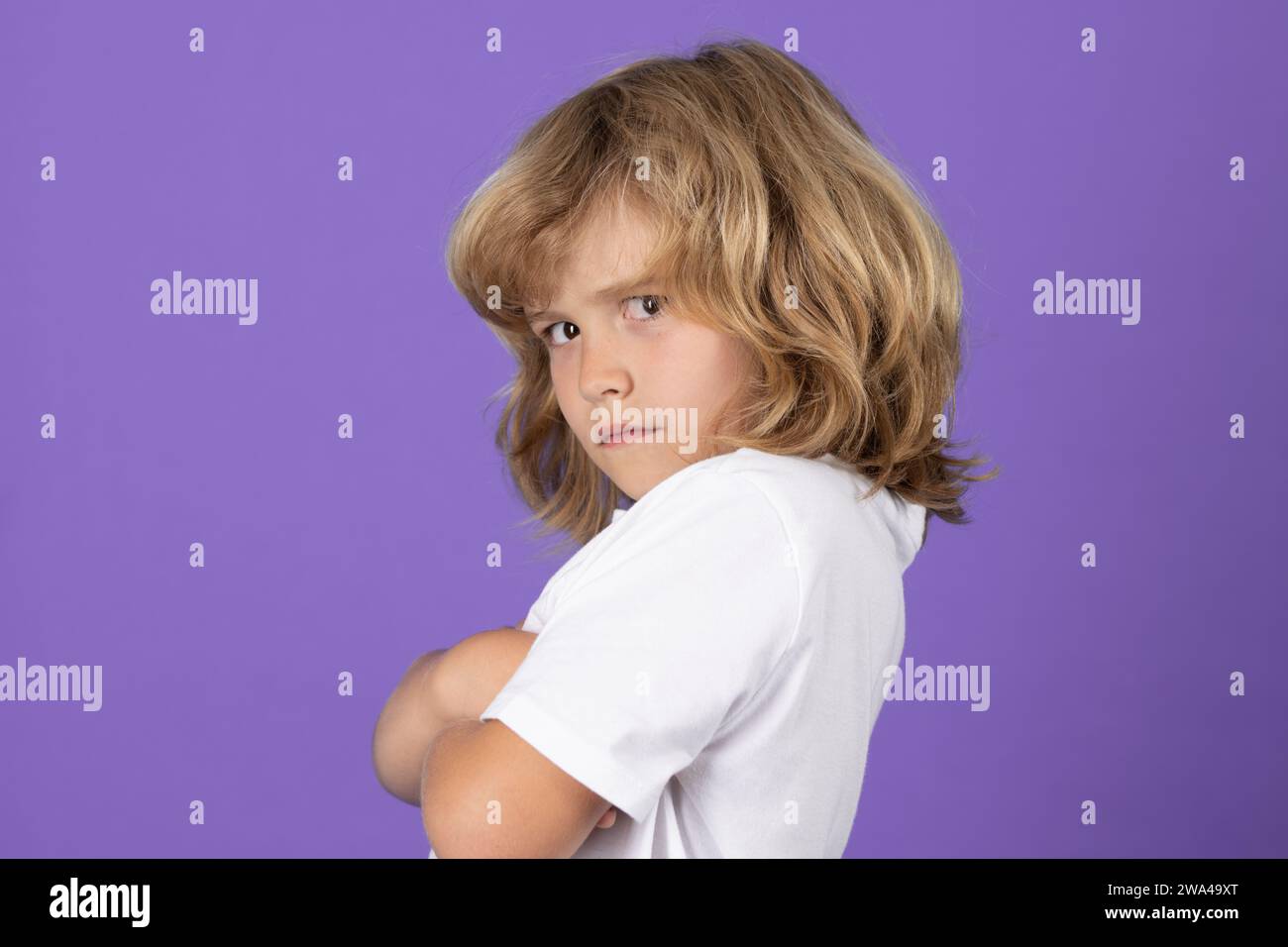 Portrait of angry child on studio isolated background. Upset kid upset ...