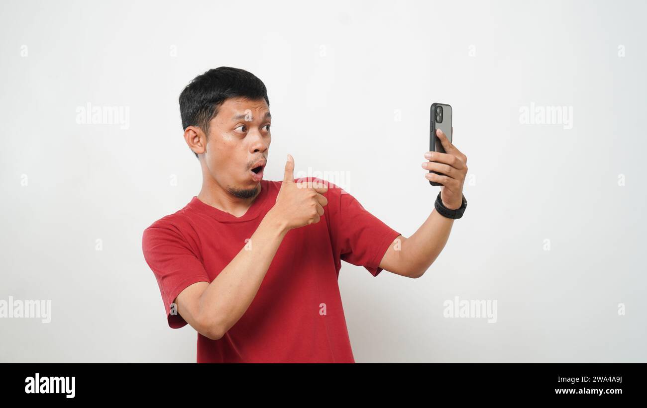 Wow face of Asian man shocked what he see in the smartphone on isolated ...