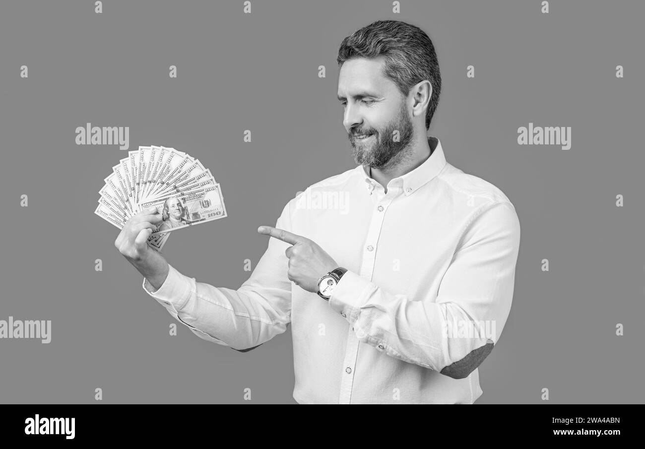 millionaire point finger on money isolated on blue background ...