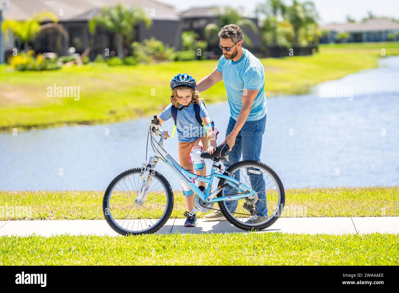 dad and son duo pedaling through picturesque landscape. supportive dad ...