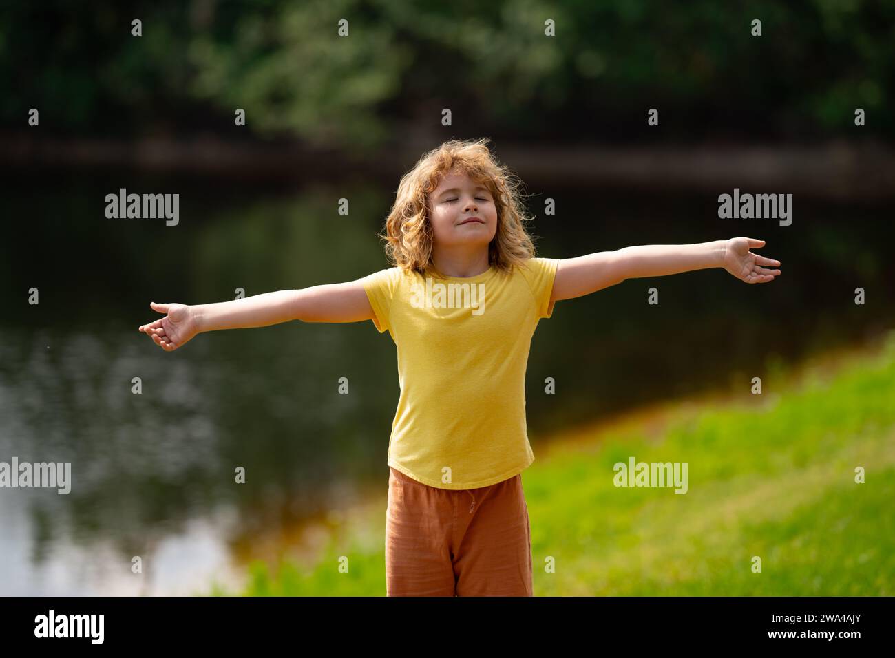 Happy child with arms up enjoying freedom in nature. Child ppen arms ...