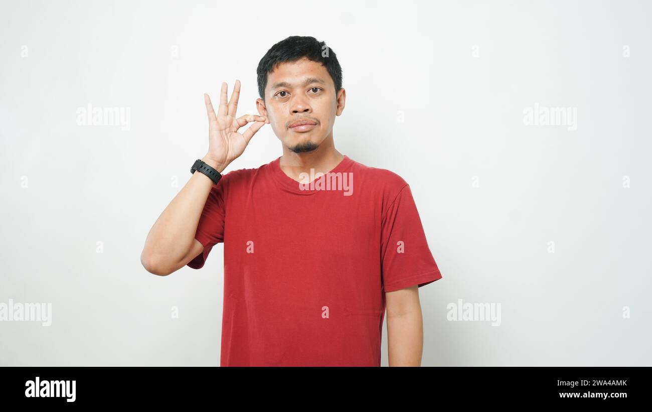 Asian man is using sign language with hand against white background ...