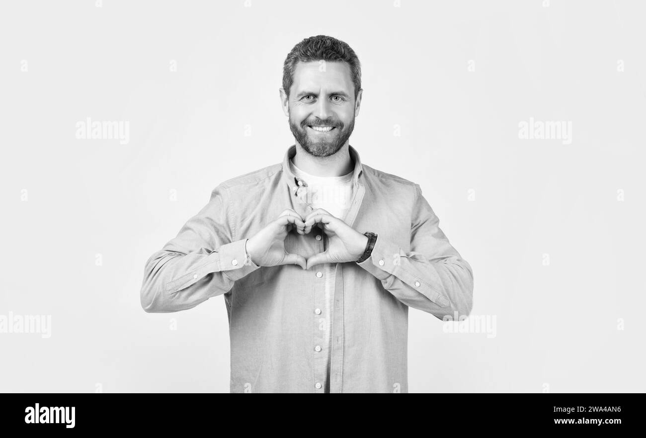 happy mature man with love heart gesture isolated on grey background ...