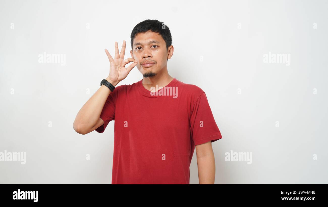 Asian man is using sign language with hand against white background ...