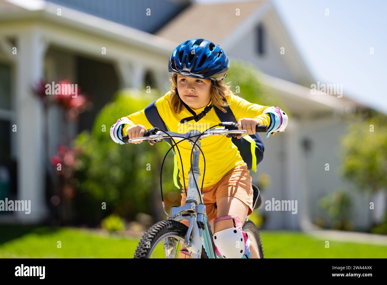Boy in a helmet riding bike. Boy in safety helmet riding bike in city ...