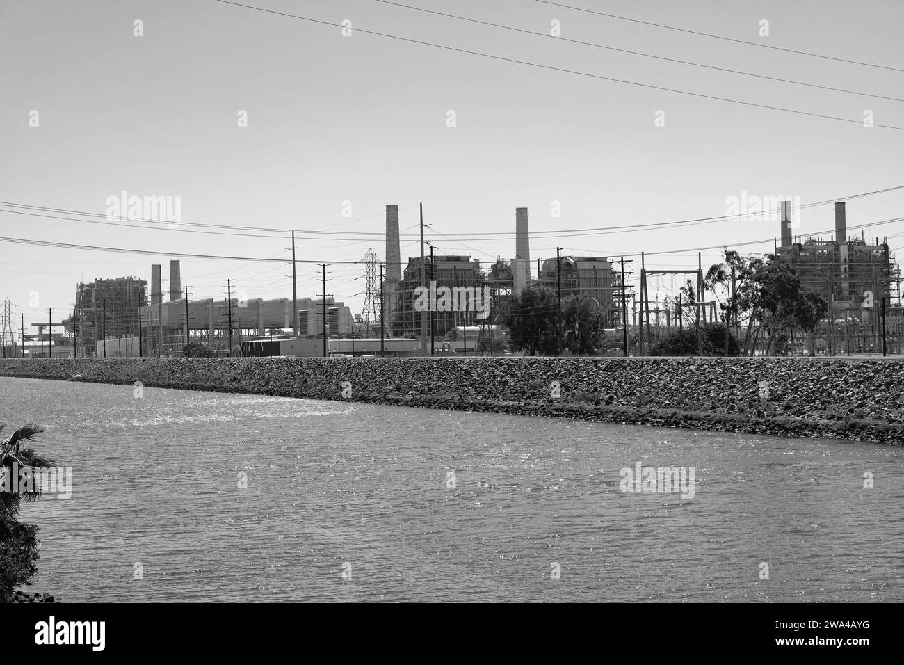 Power station with river in foreground. Power generating plant ...