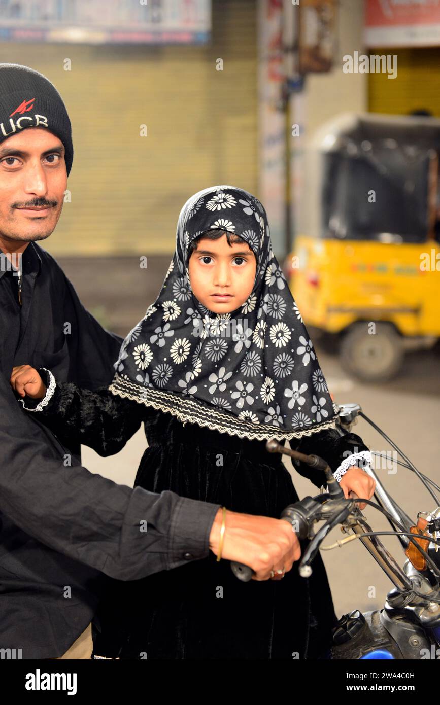 Portrait of a Shia Indian man with his young girl wearing hijab ...