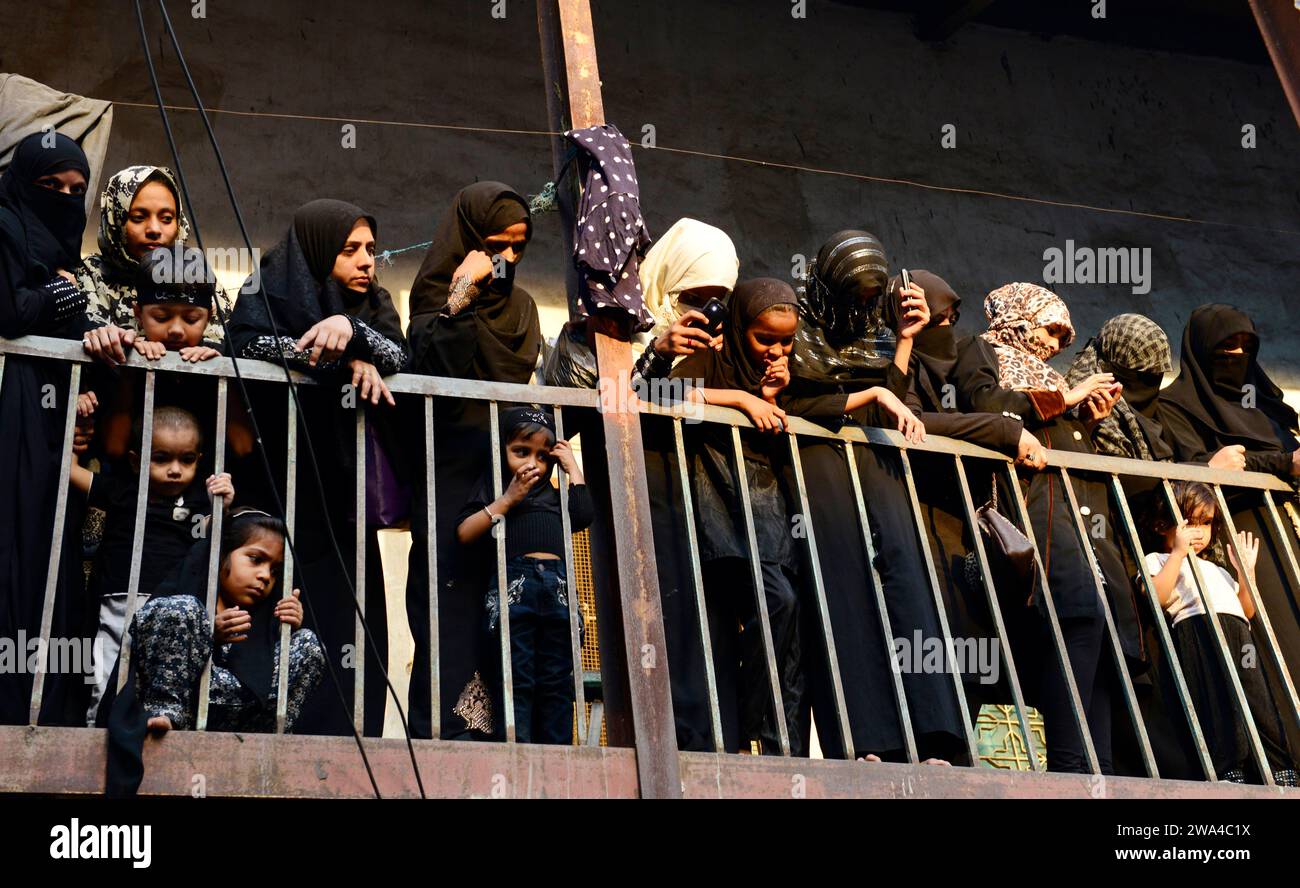 Shia women looking down at the religious procession around the Iranian ...