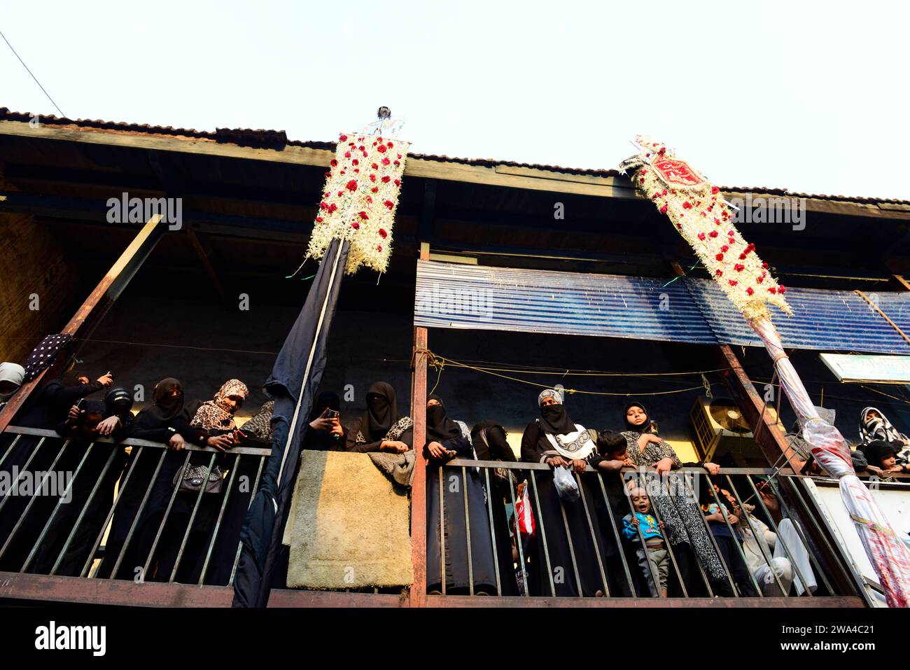 Shia women looking down at the religious procession around the Iranian ...