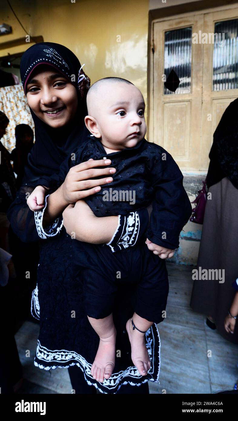 A young Shia woman holding her baby Stock Photo - Alamy