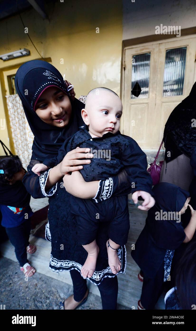 A young Shia woman holding her baby Stock Photo - Alamy