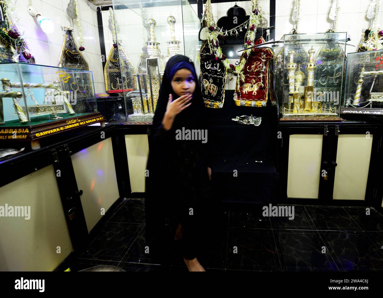 A young Shia Muslim pilgrim visiting a site representing the story of ...