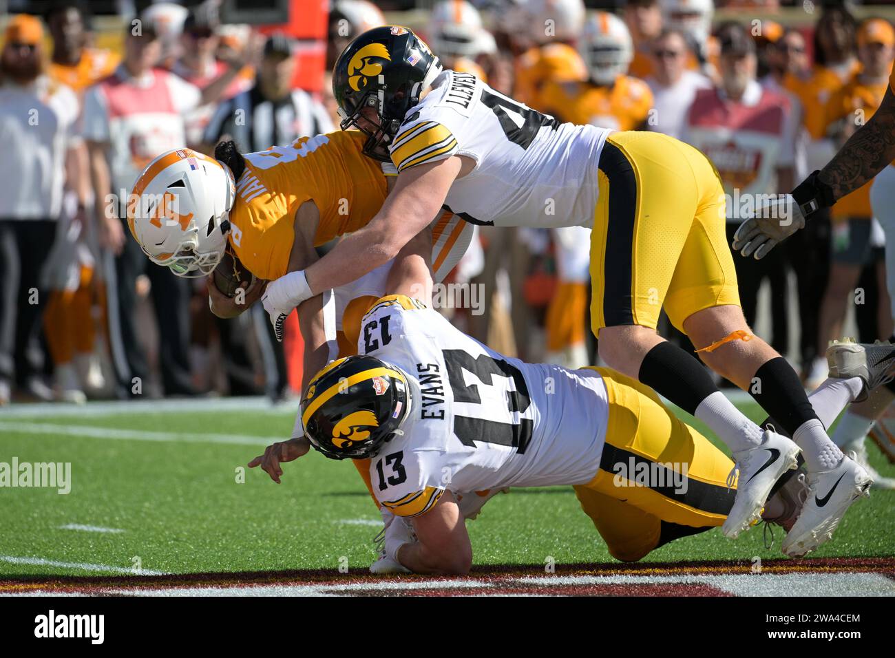 Tennessee quarterback Nico Iamaleava (8) is sacked by Iowa defensive end Joe Evans (13) and ...