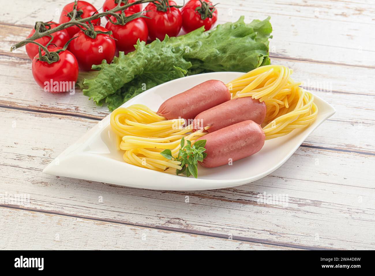 Mini sausages with pasta spaghetti for kids Stock Photo - Alamy