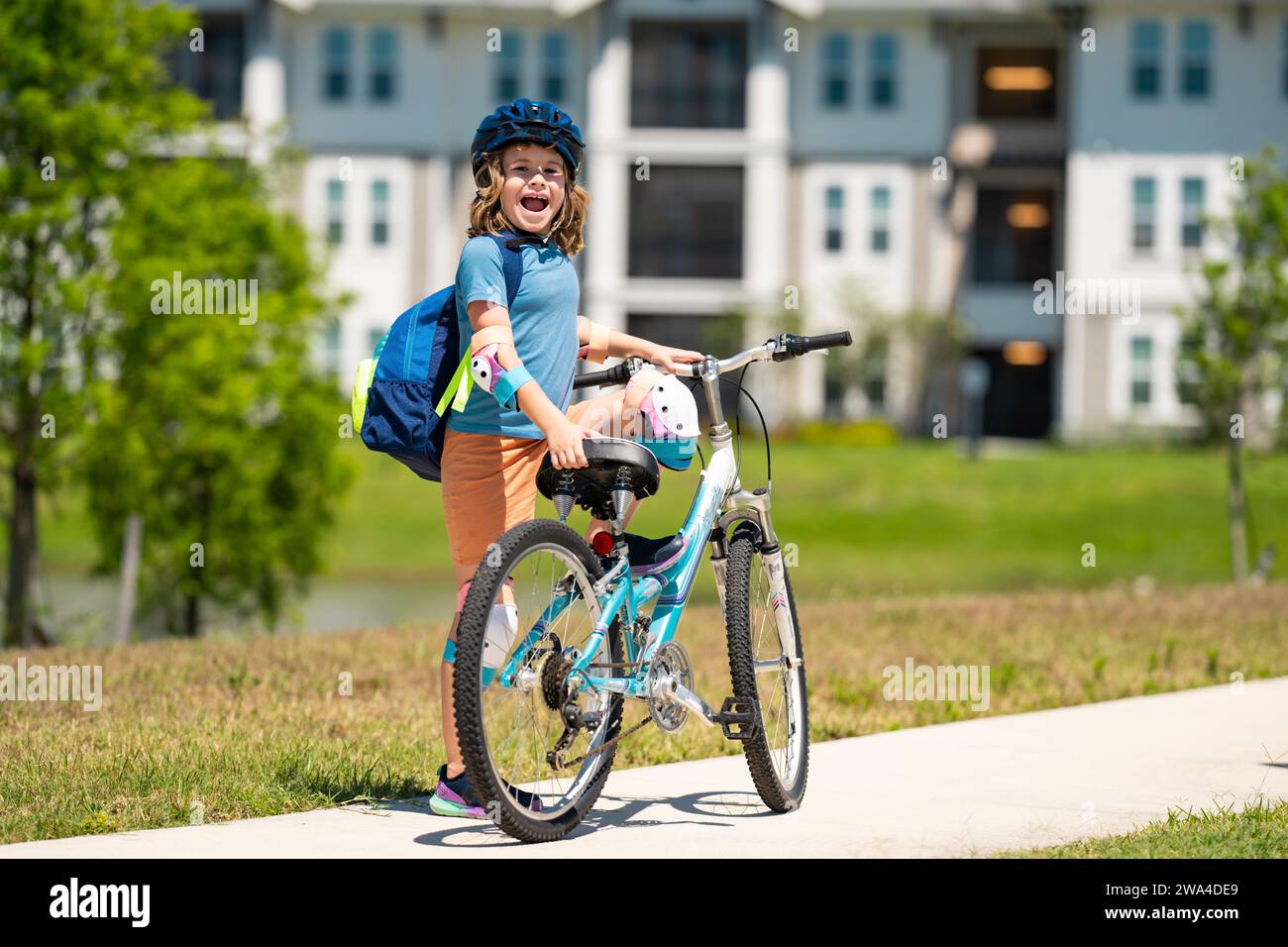 Little kid boy riding a bike in summer park. Child drive a bike on a ...