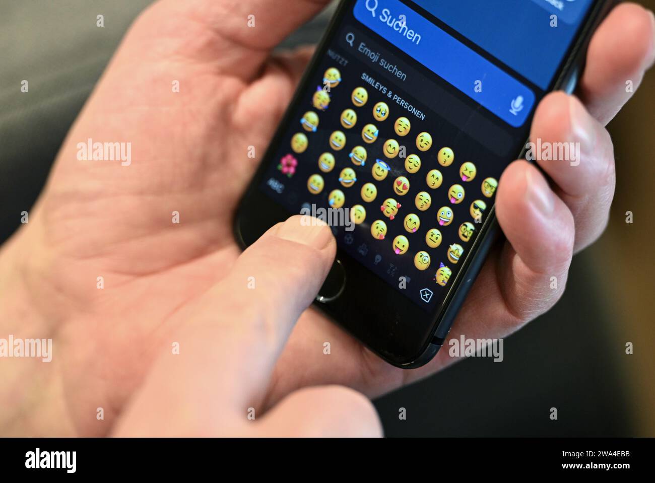 Berlin, Germany. 13th Dec, 2023. ILLUSTRATION - A man taps with one ...