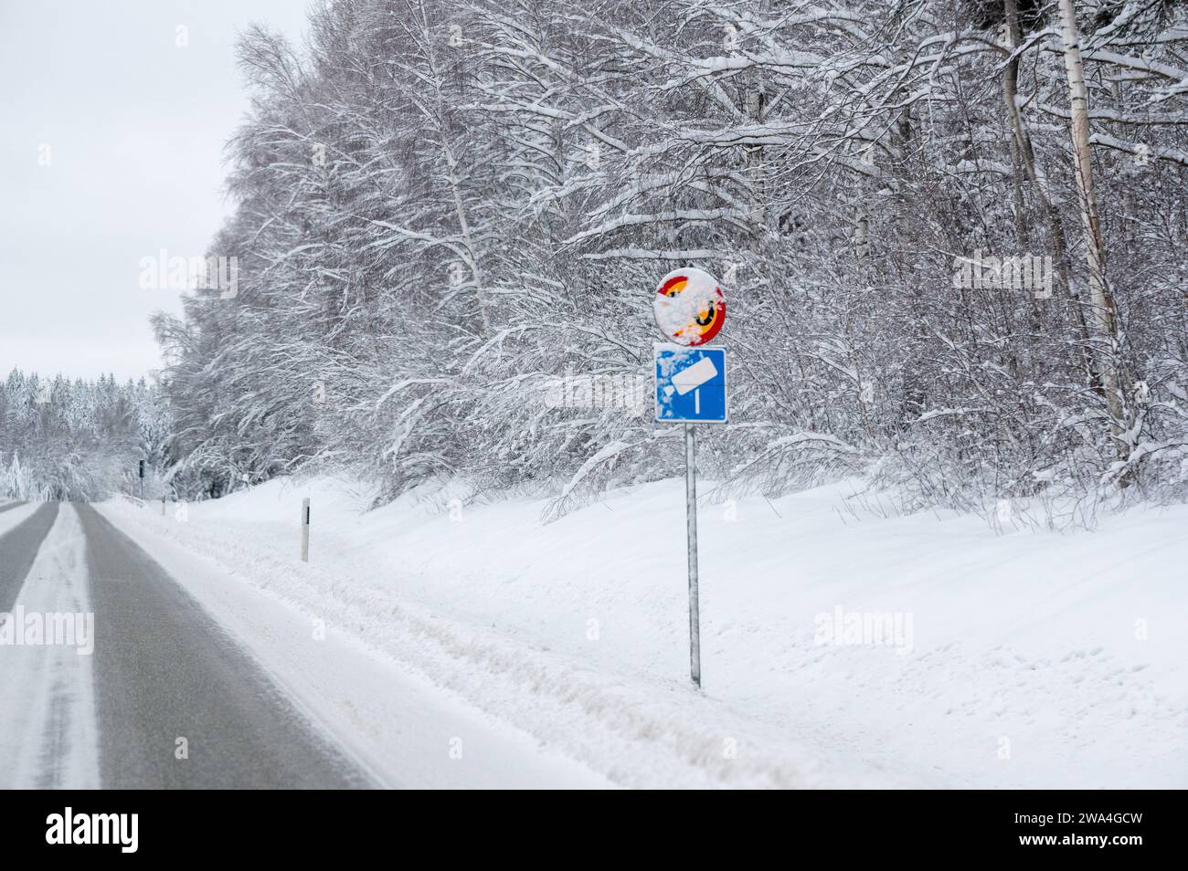 Signs with speed limit and speed camera covered in snow Stock Photo - Alamy