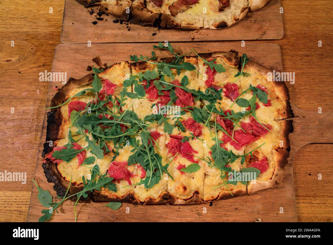 Flammekueche or tarte flambee with fromage blanc cheese, cured ham and ...