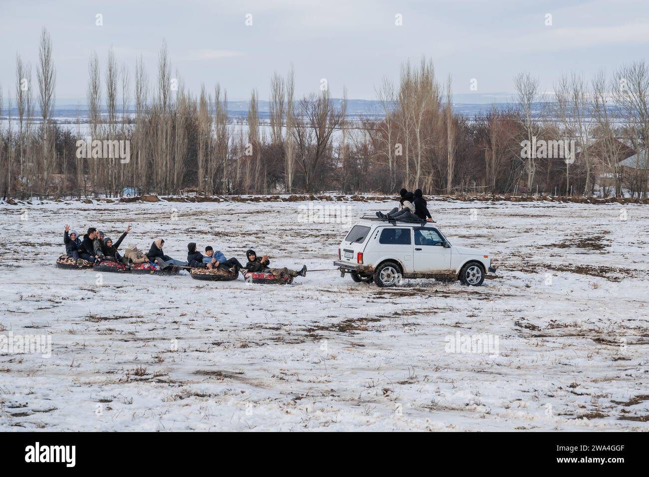 TAU SAMALY, KAZAKHSTAN - DECEMBER 23, 2023: happy Kazakh children ride ...