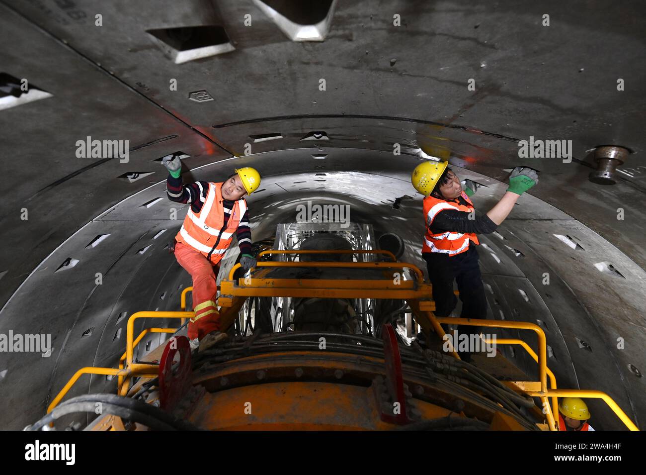 Beijing, China. 2nd Jan, 2024. Staff members install tube components at ...
