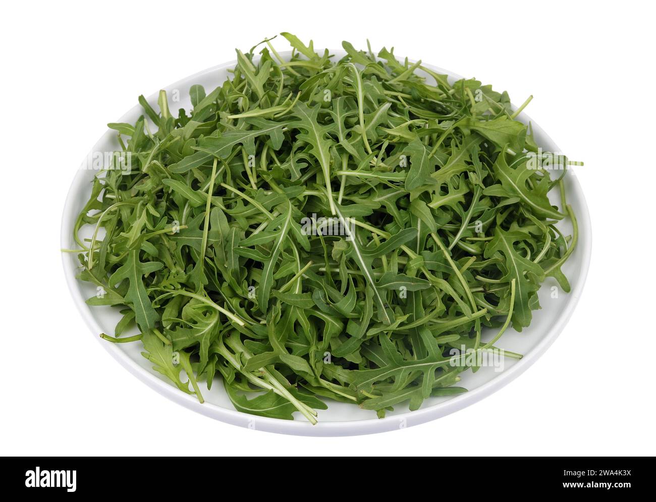 Bunch of fresh spring mustard leaves on a ceramic plate isolated Stock ...