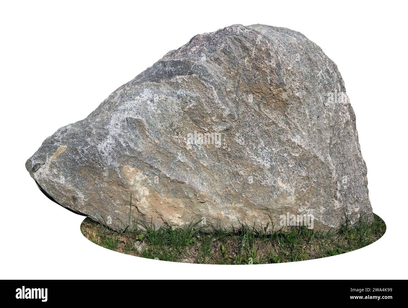 Big gray granite stone on green grass isolated Stock Photo - Alamy