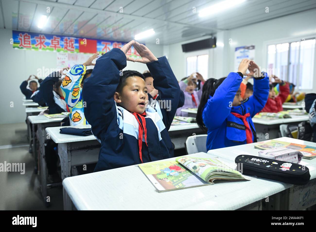 Haidong, China's Qinghai Province. 2nd Jan, 2024. Students sing before ...