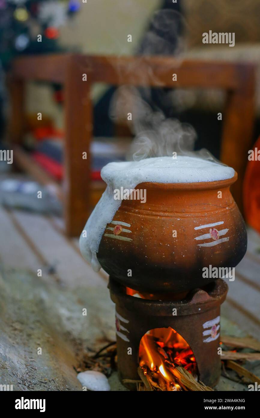 Old pot used for boiling milk in fire wood soil pot. Cultural event in ...