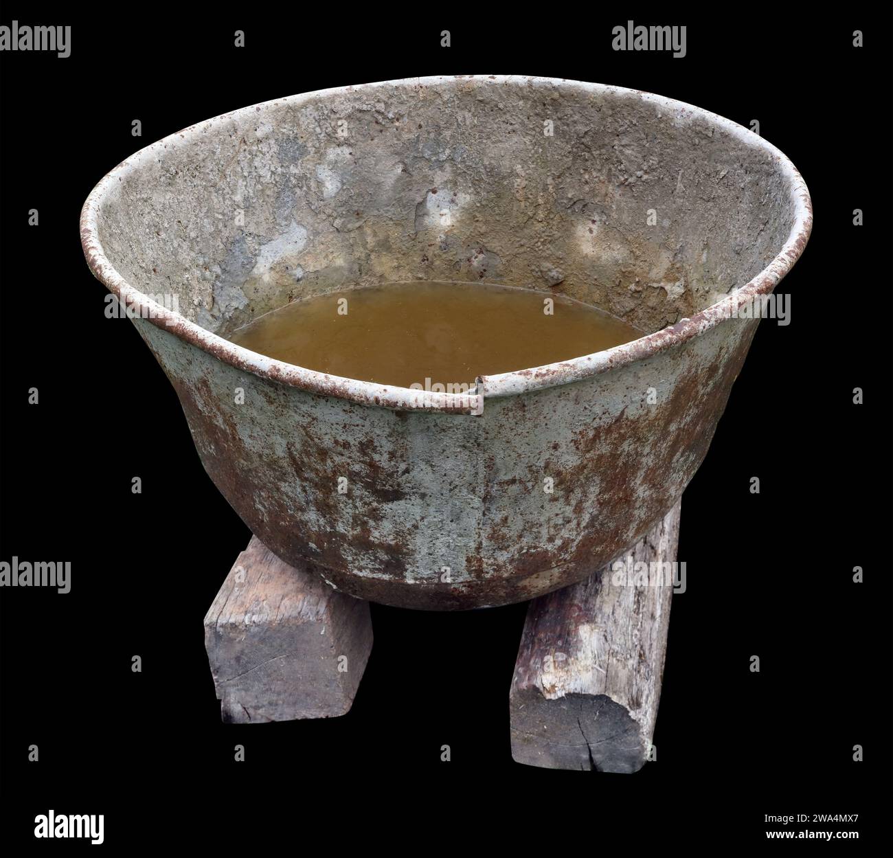 A huge old rusty pot filled with rainwater. Isolated on iron Stock ...