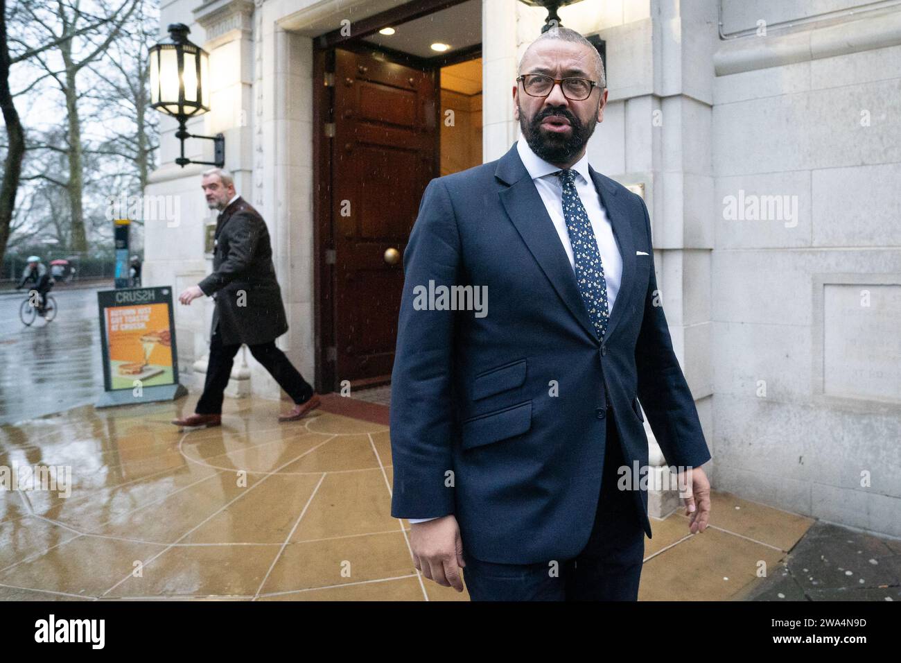 Home Secretary James Cleverly, followed by Giles Dilnot, leaves the ...