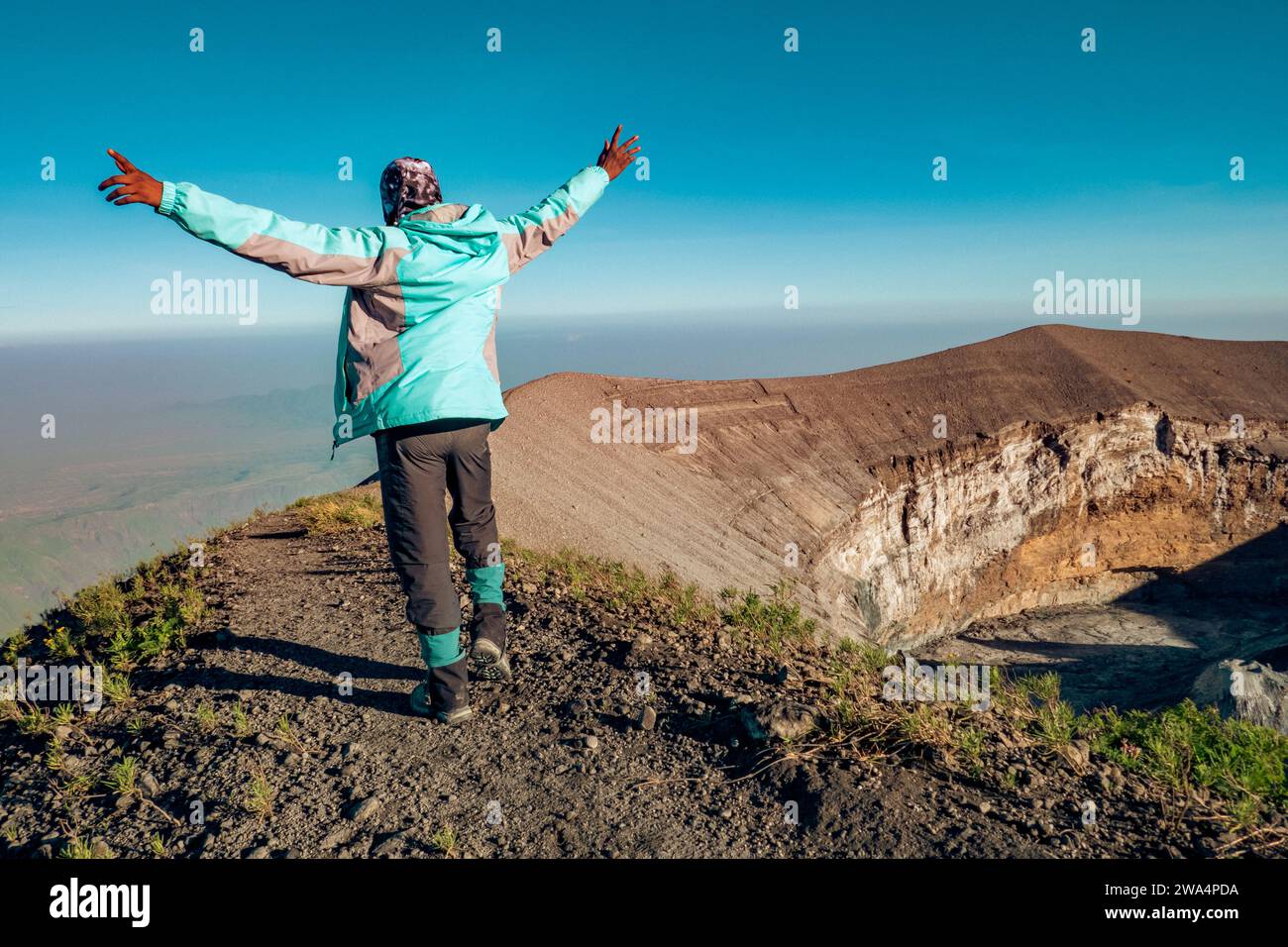 View of a hiker at the volcanic crater - The Ash Pit of Mount Ol Doinyo ...