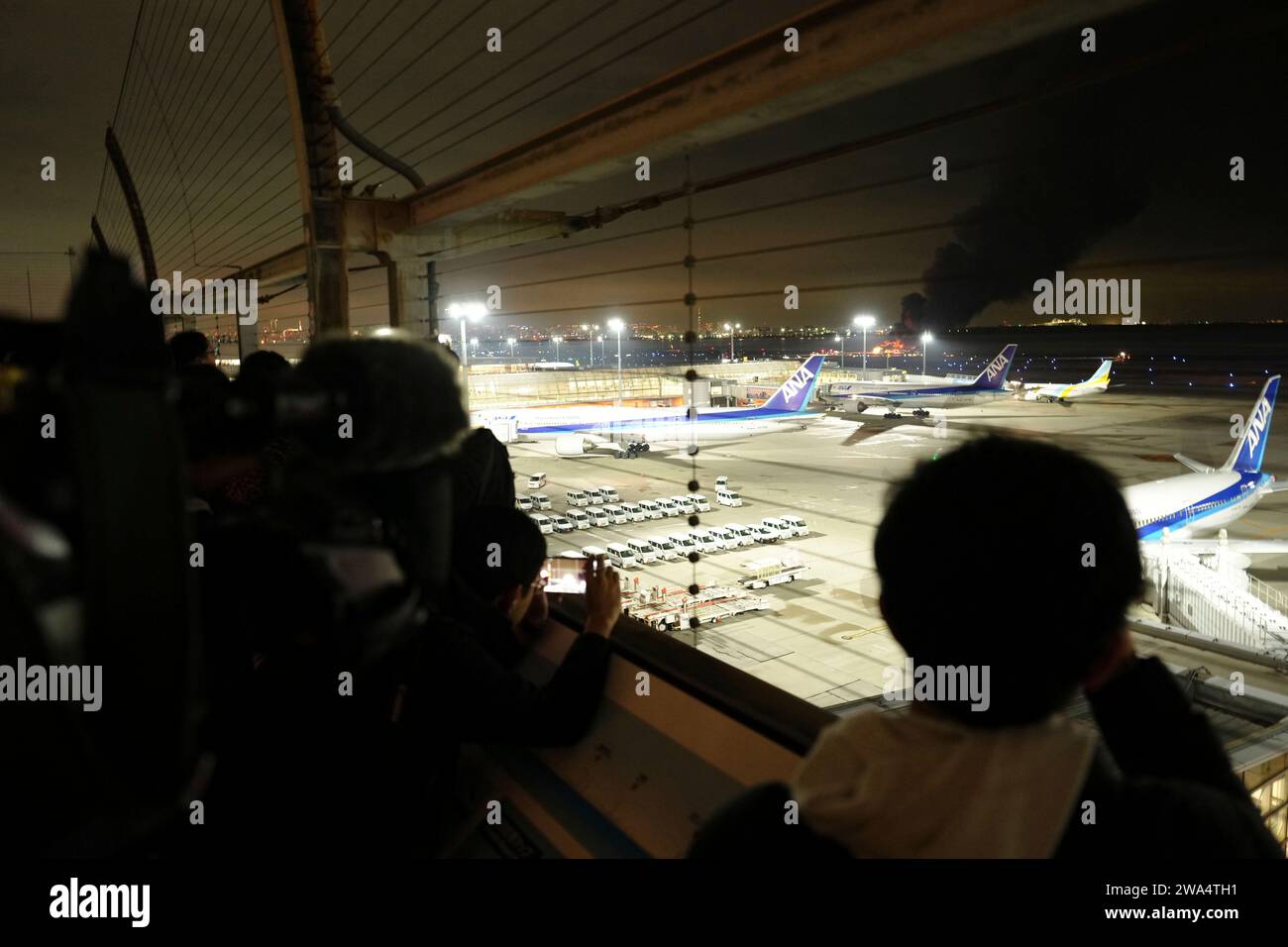A Japan Airlines plane catches fire on the runway at Haneda Airport in ...