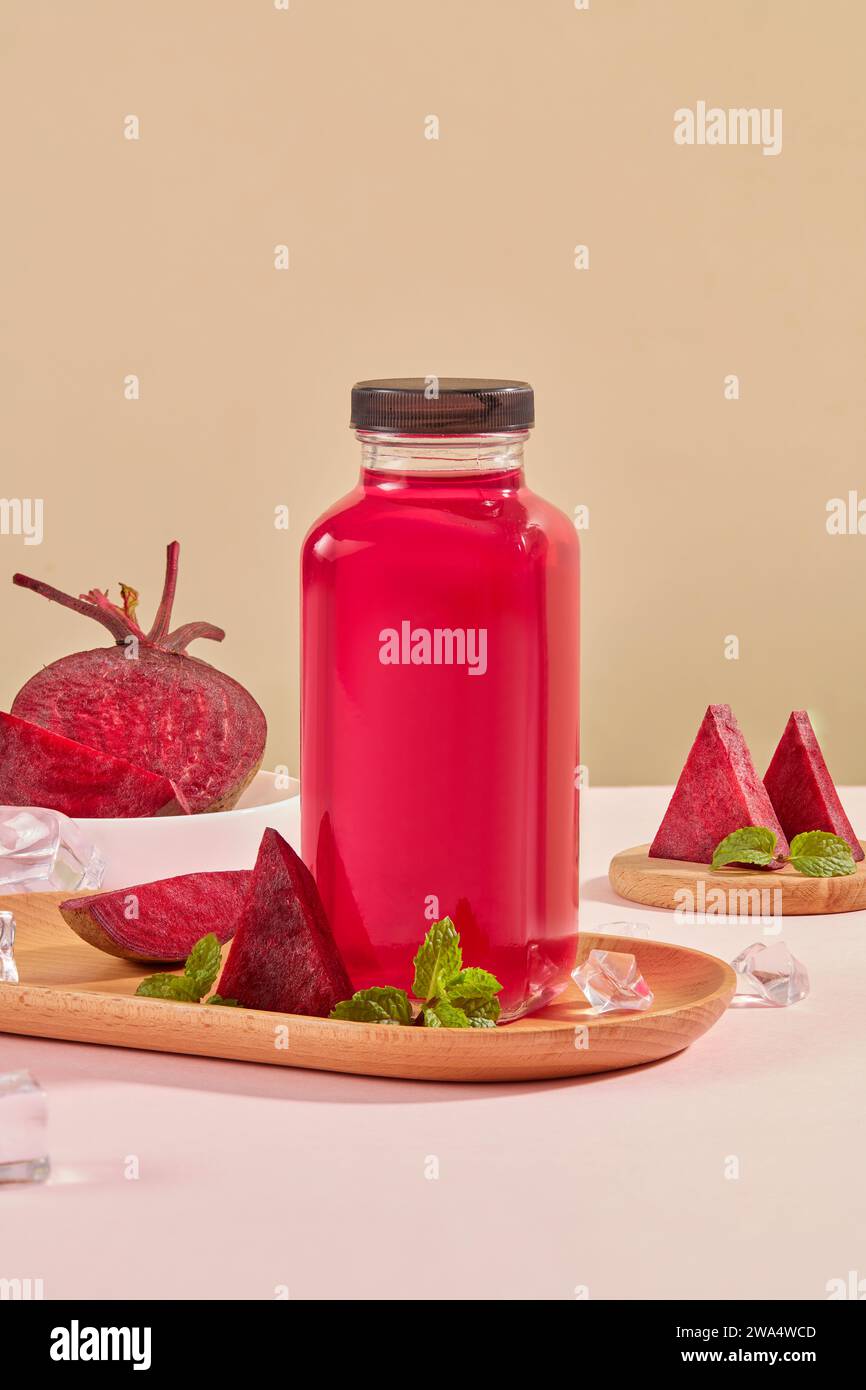 Fresh beetroot slices decorated with glass bottle unlabeled containing ...