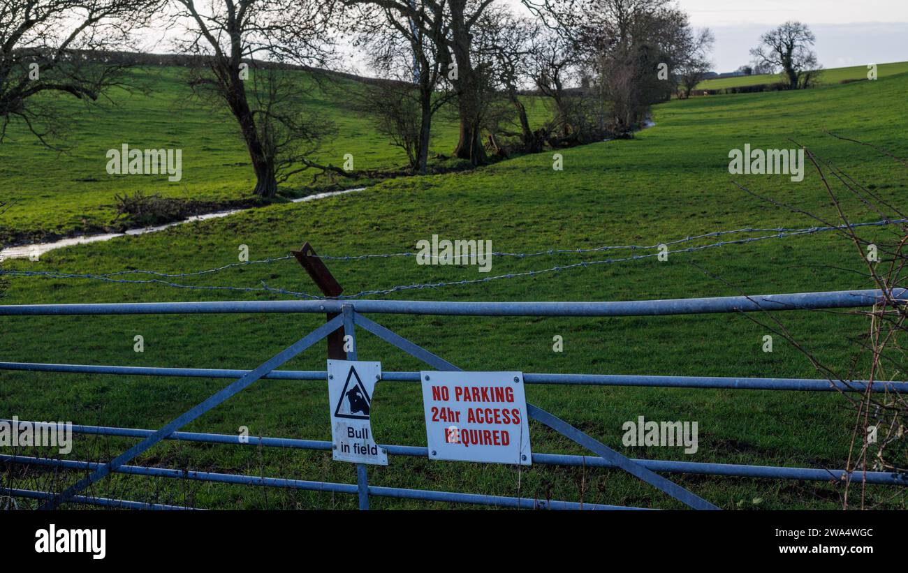 closed metal gate with warning signs in the English countryside Stock ...