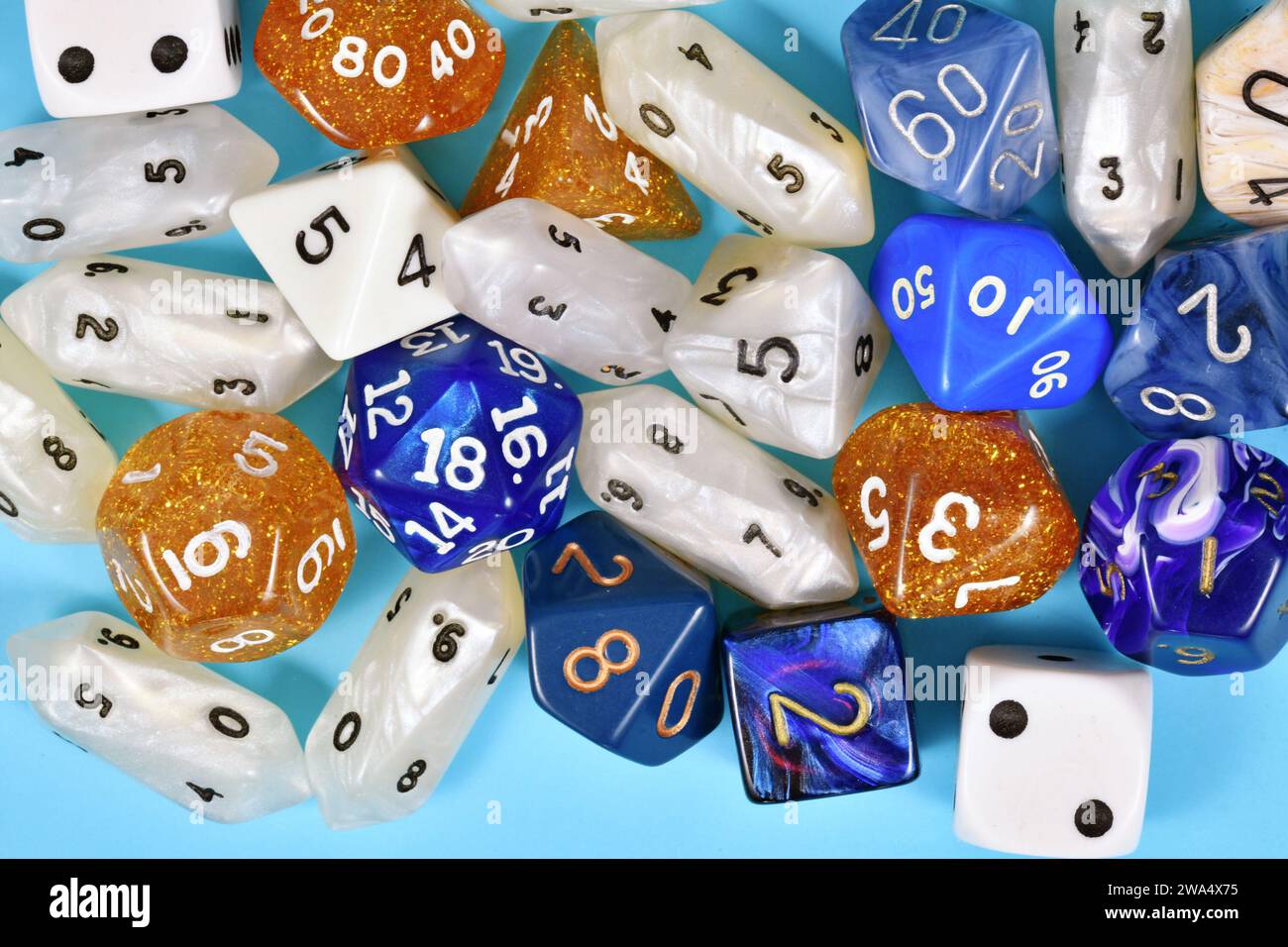 Different blue, white and golden roleplaying RPG dice Stock Photo - Alamy
