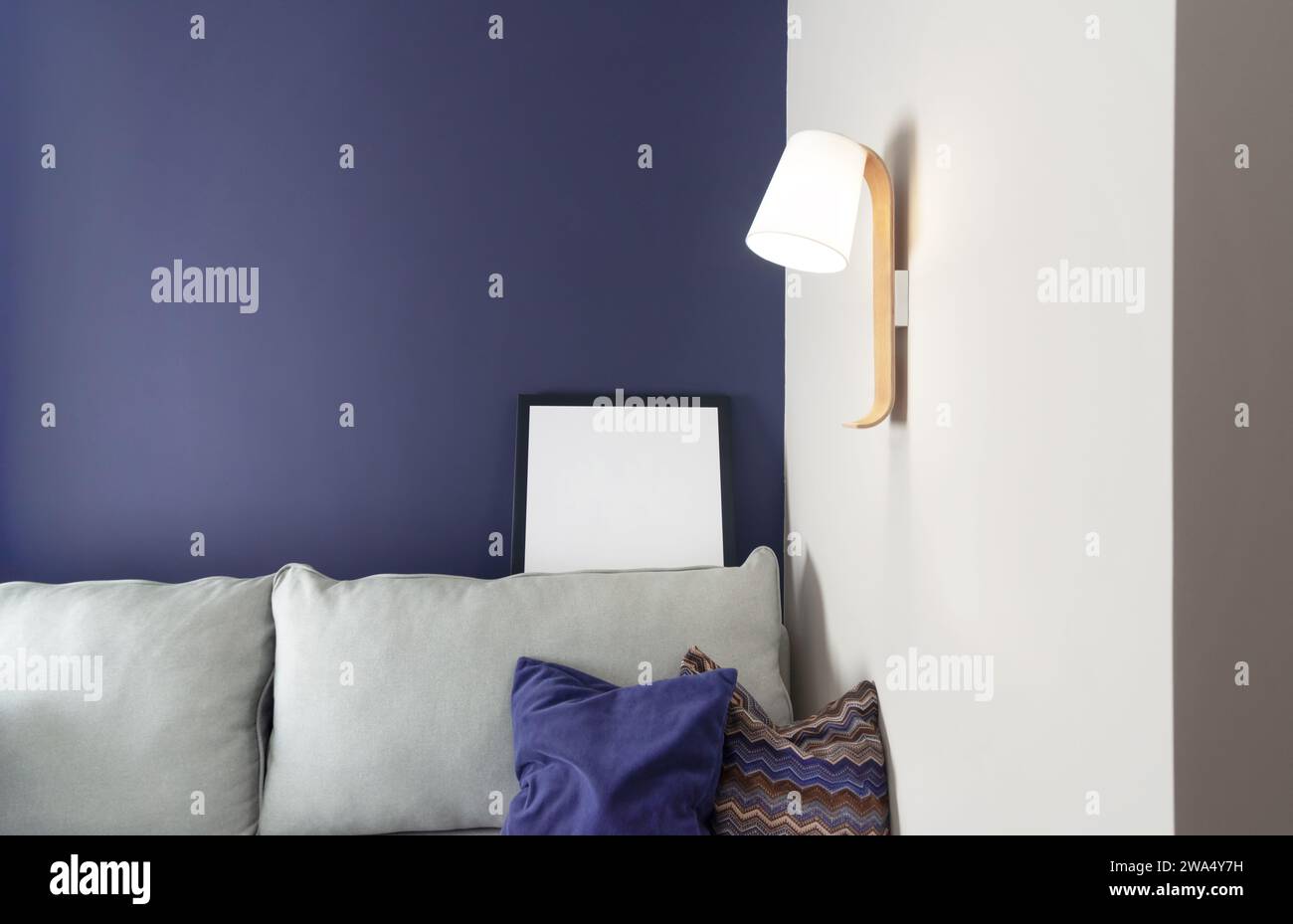 Living room interioir in a minimalist style with soft blue walls, sofa ...