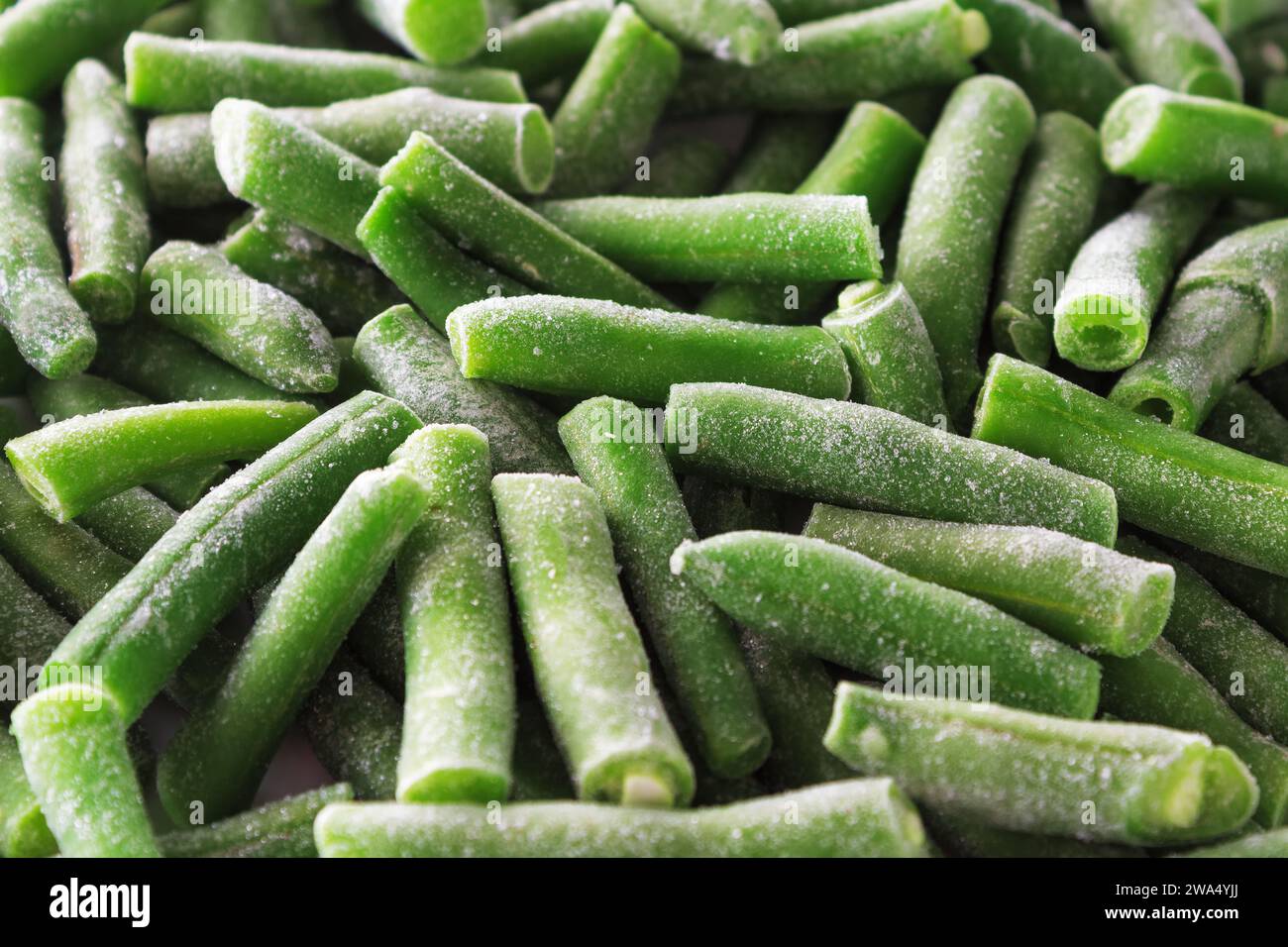Close-up of frozen green beans covered with ice. Frozen vegetables ...
