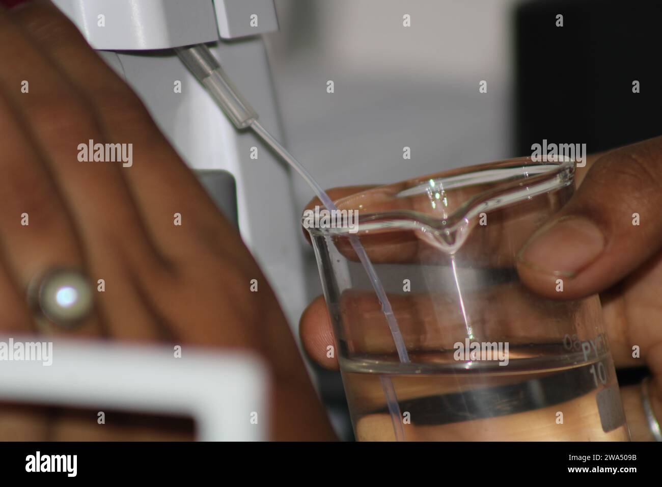 A Semi Auto Chemistry Analyzer drawing water from a glass pipe.India ...