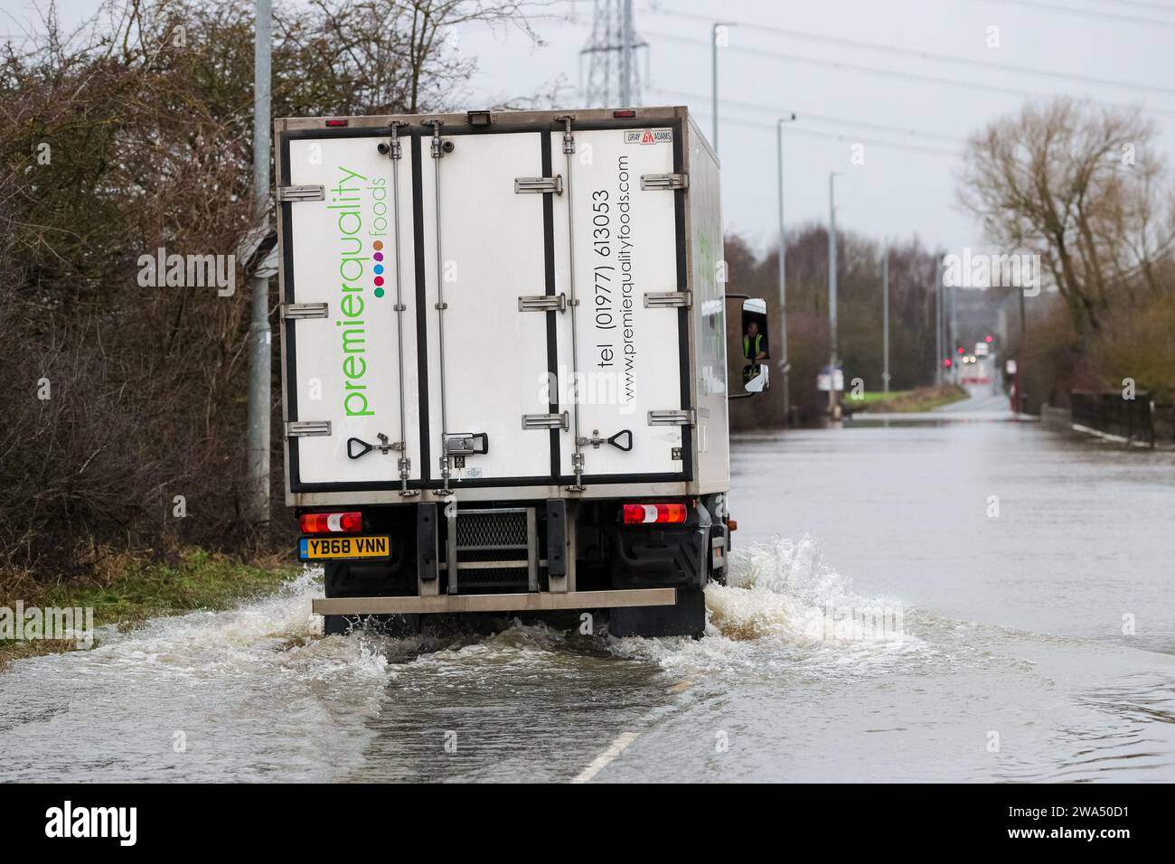 A lorry makes it’s way through the flooded road caused by storms and ...