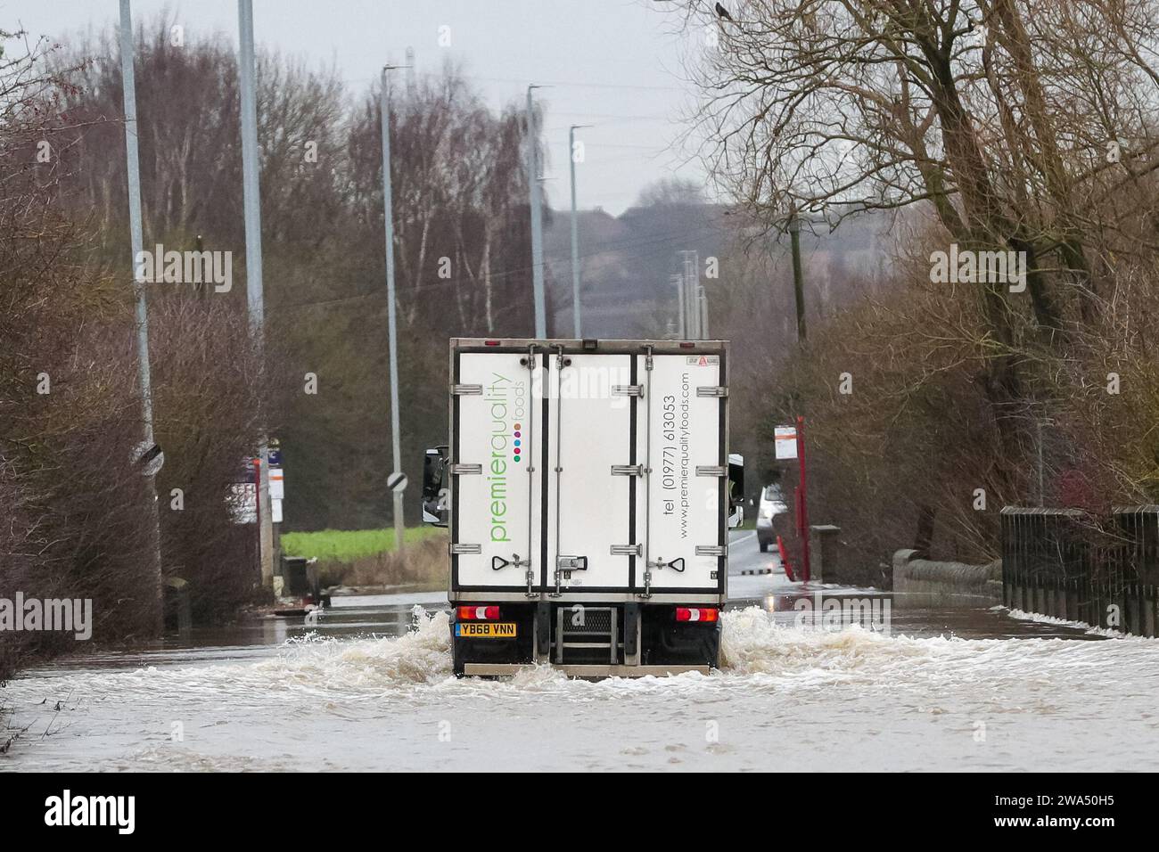 A lorry makes it’s way through the flooded road caused by storms and ...
