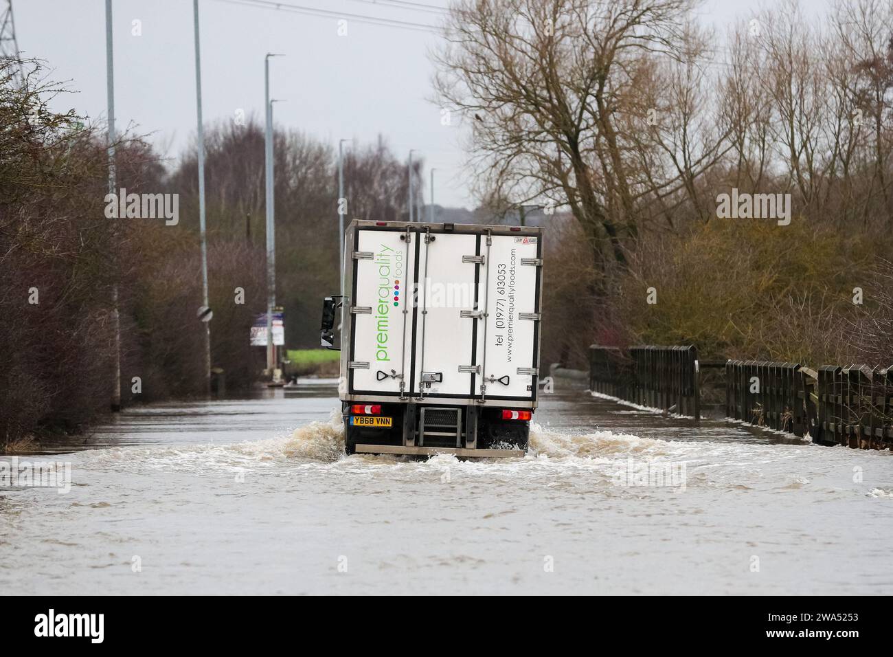 A lorry makes it’s way through the flooded road caused by storms and ...