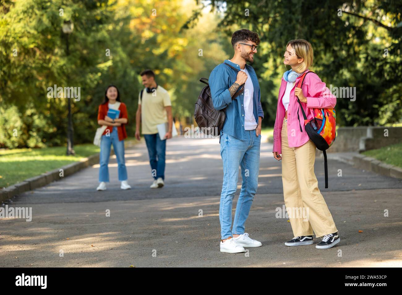 Group of young people having a walk in the park Stock Photo - Alamy