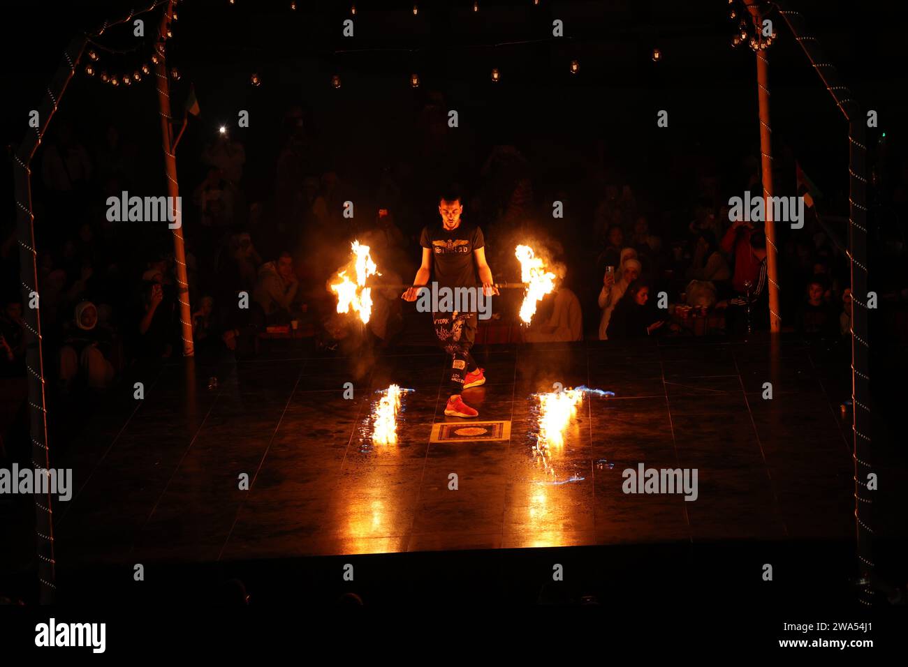29th December 2023, Dubai, UAE. A man performing fire dance in Desert ...
