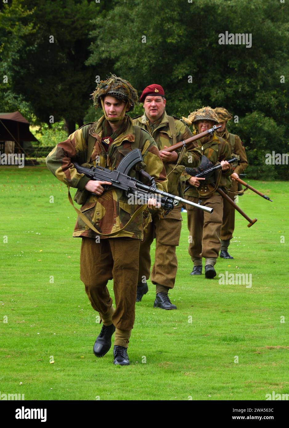 Re-enactment World War 2 group of four men in British WW2 uniforms with ...