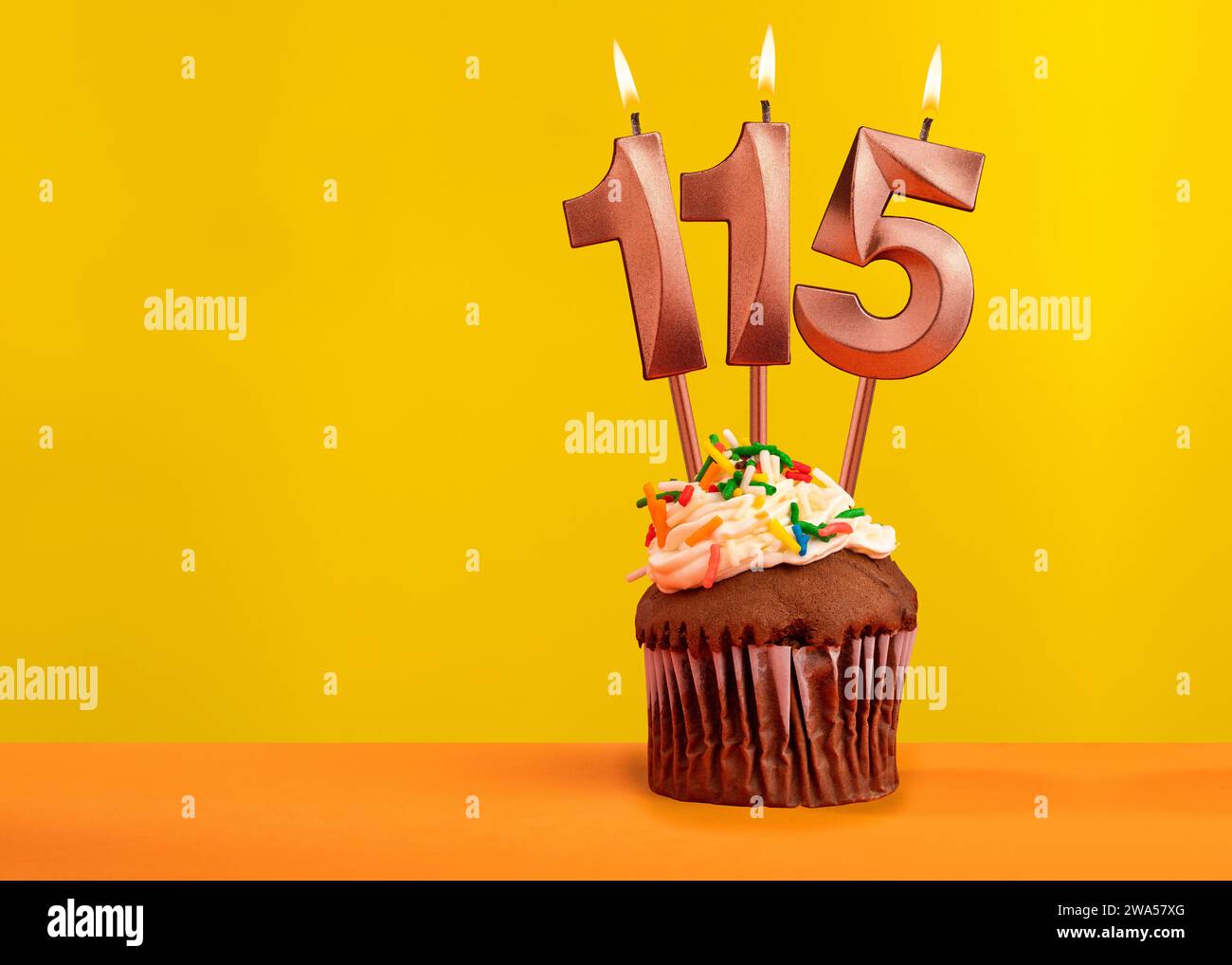 Candle with flame number 115 - Birthday card on yellow background Stock ...