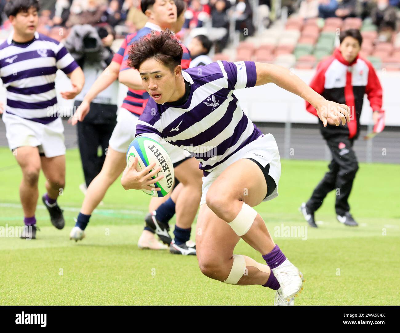 Tokyo, Japan. 2nd Jan, 2024. Meiji University fly half Kotaro Ito carries the ball into the end ...