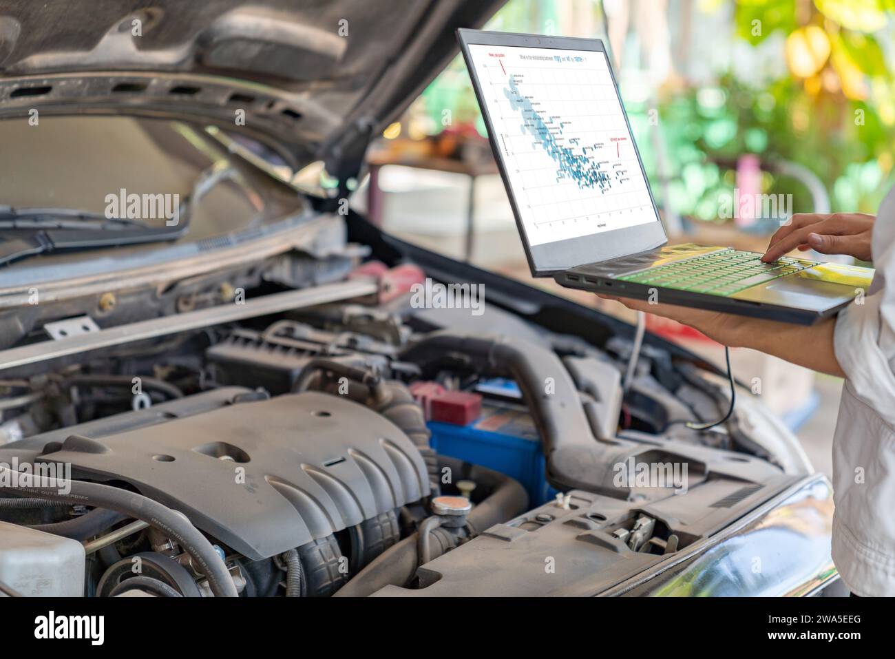 Mechanic work tune torque engine in ecu with laptop computer in auto ...