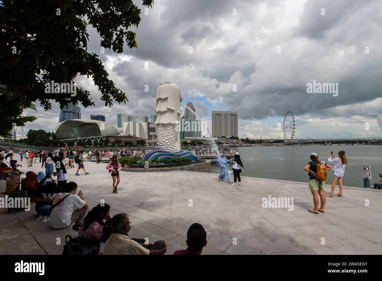 02 January 2024. Hot and humid weather. Tourists sit under the shade ...